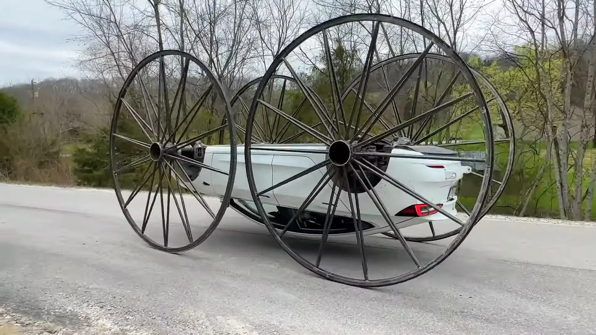 WhistlinDiesel Drives a Tesla Upside-Down on 10-Foot Tall Wheels
