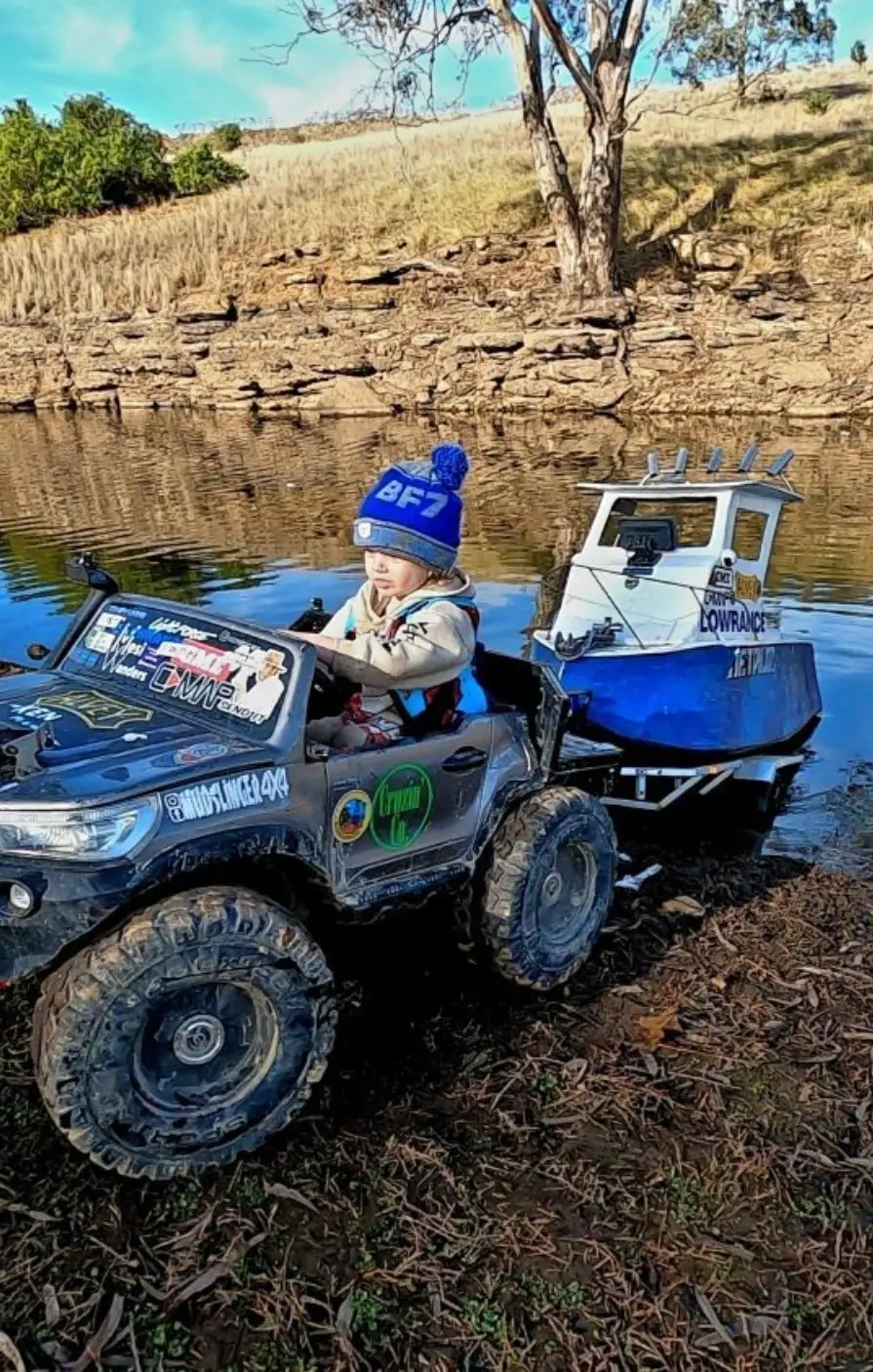 Little Boy Backing Up Trailer With Mini Boat in His Tiny Toyota Is Adorable
